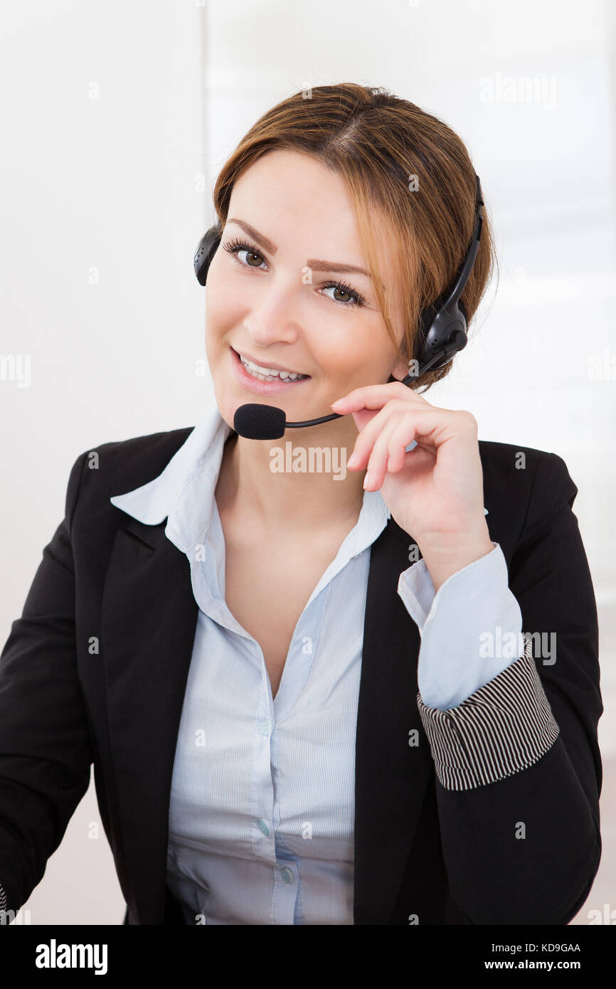 Portrait Of Happy Young Female Operator With Headphones Stock Photo - Alamy