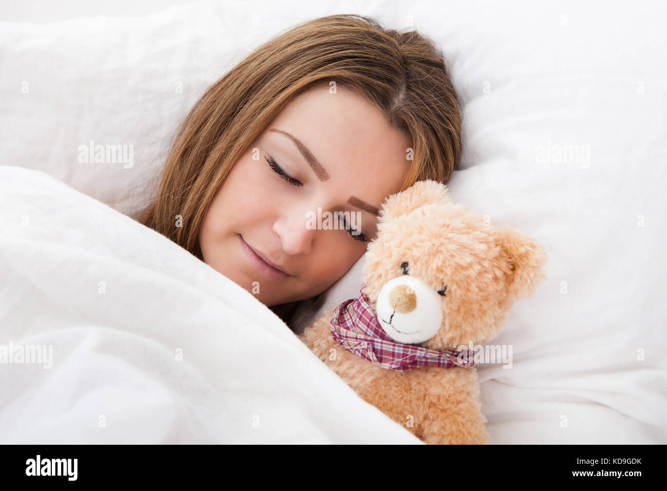 Young Beautiful Woman Sleeping On Bed With Her Teddy Bear Stock Photo ...