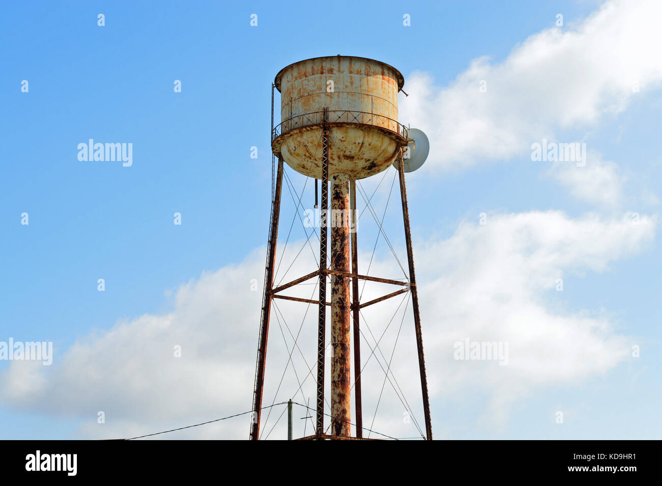 Old rusty water tower in the skyline of a small town Stock Photo - Alamy
