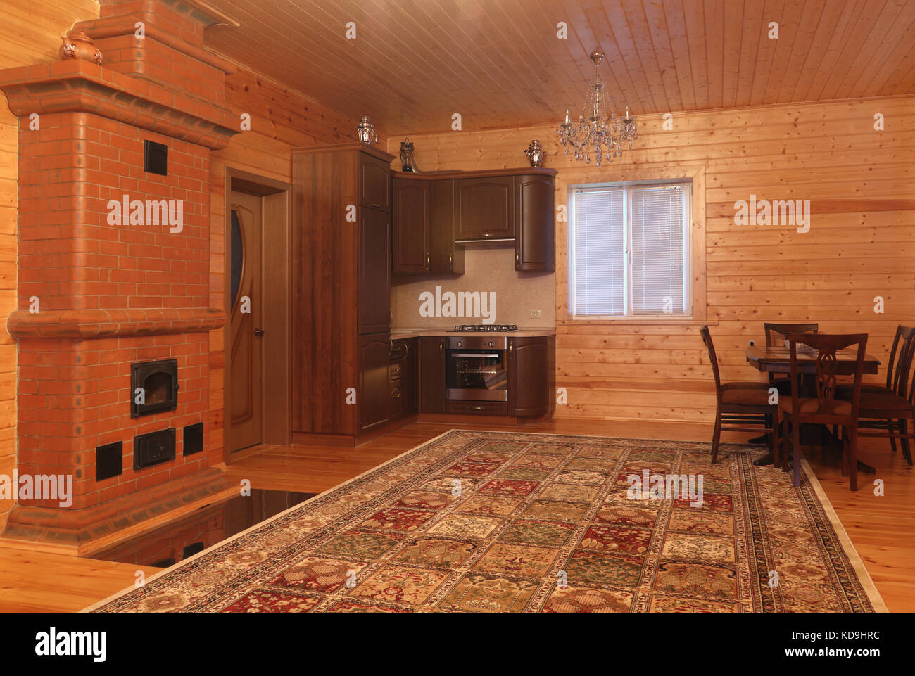 Wooden house interior with table and kitchen unit photo Stock Photo - Alamy