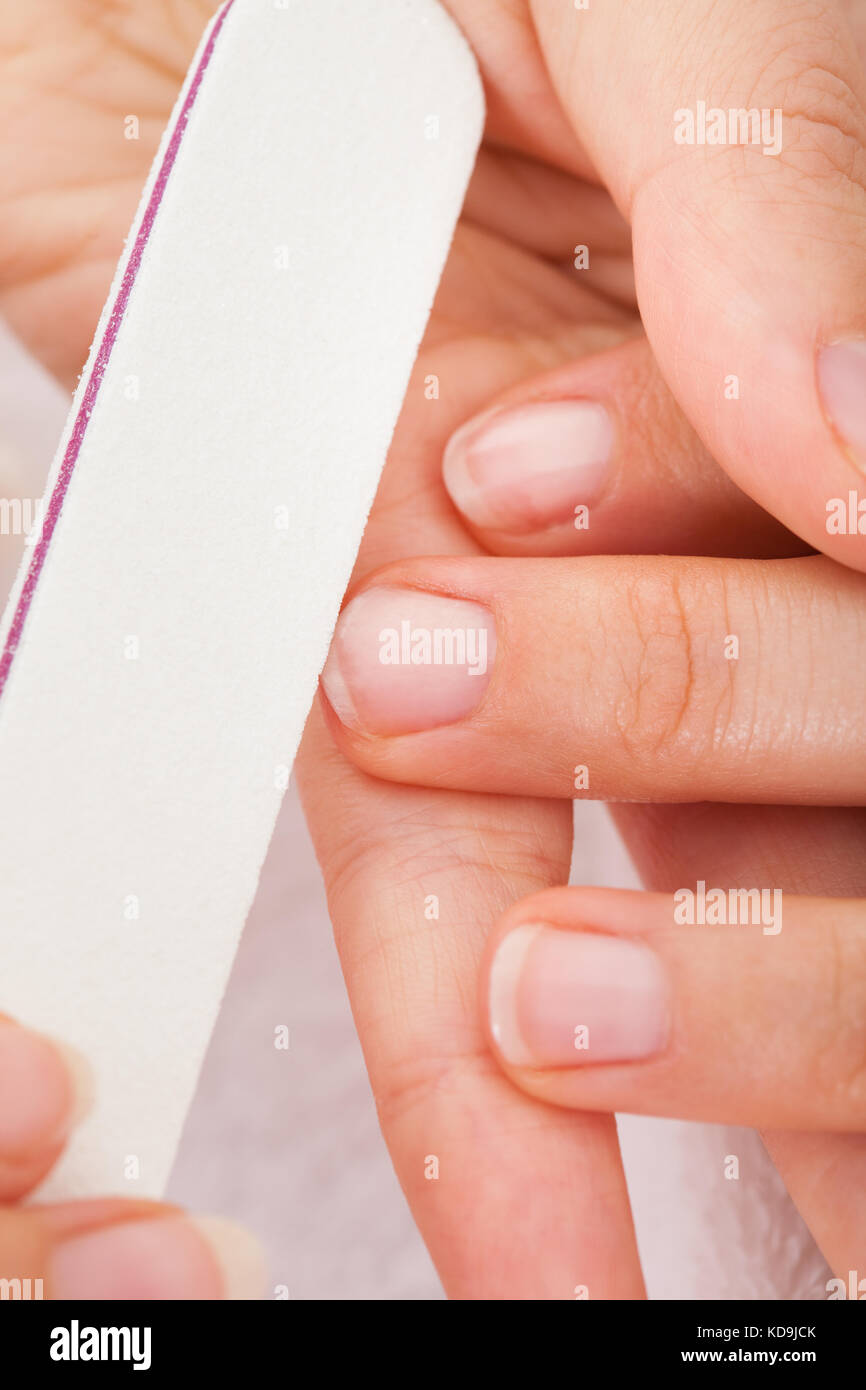 Close-up Of Beautician Hand Filing The Nails Of Woman Stock Photo - Alamy