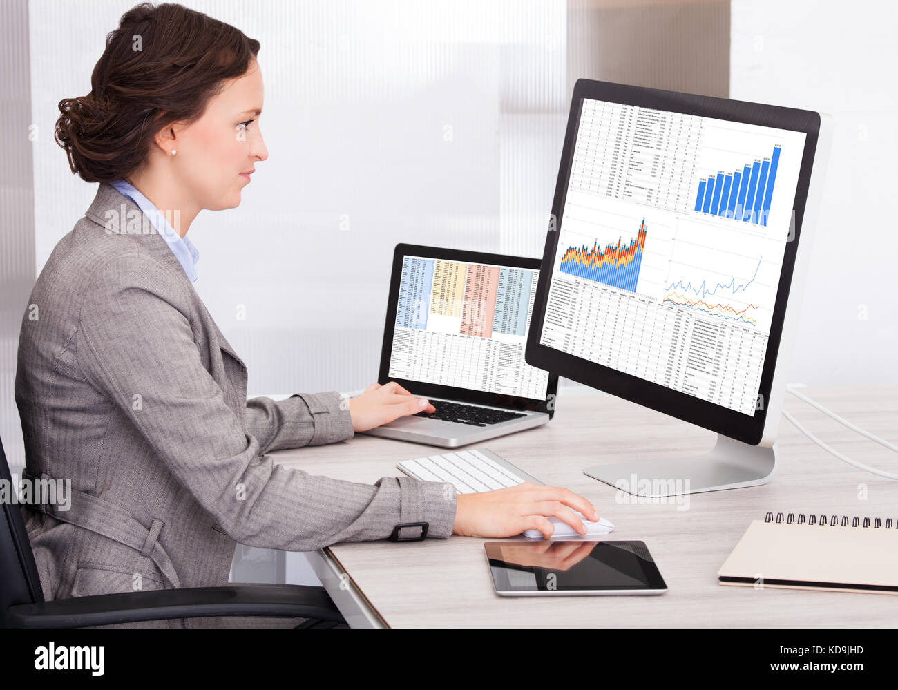 Portrait Of Young Businesswoman Analyzing Graph On Computer Stock Photo ... Portrait Of Young Businesswoman Analyzing Graph On Computer Stock Photo ...