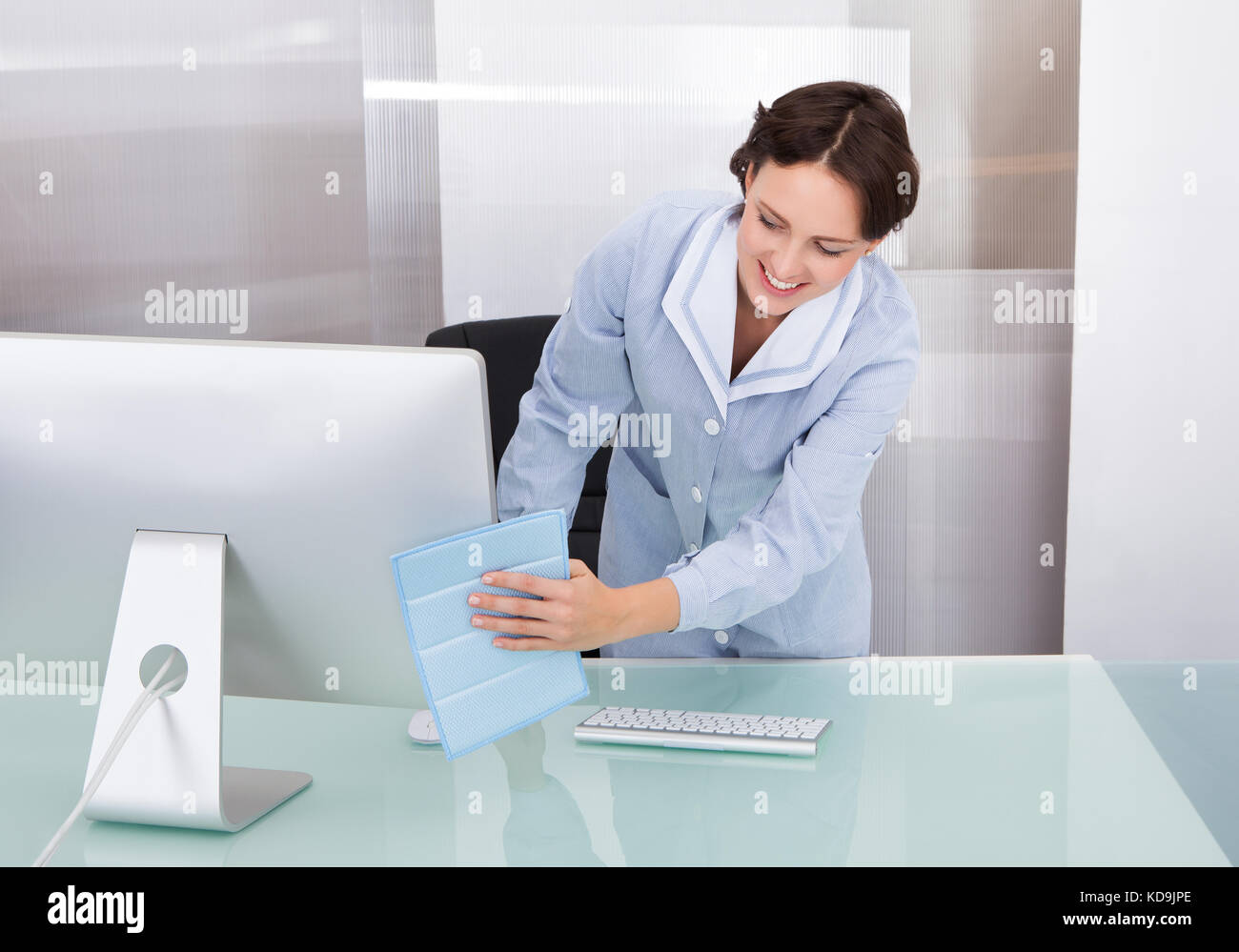Portrait Of Happy Female Janitor Cleaning Desk At Office Stock Photo ...