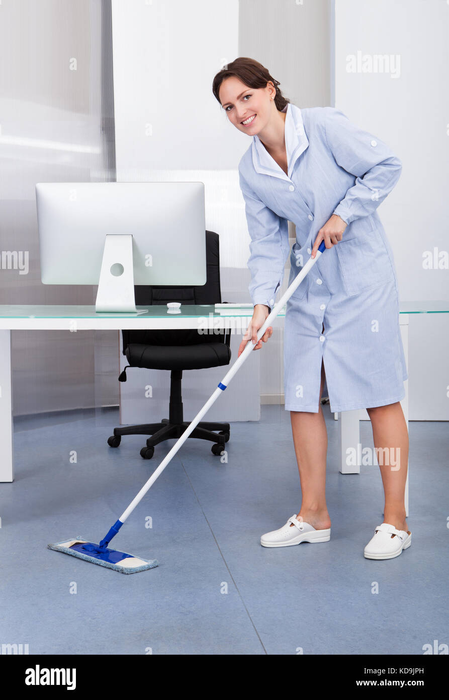 Portrait Of Happy Female Janitor Cleaning Floor At Office Stock Photo ...