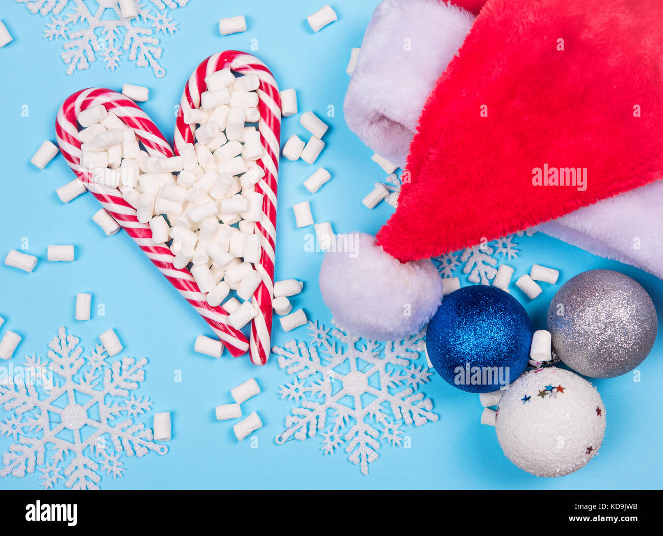 Christmas candy canes on a blue background Stock Photo - Alamy