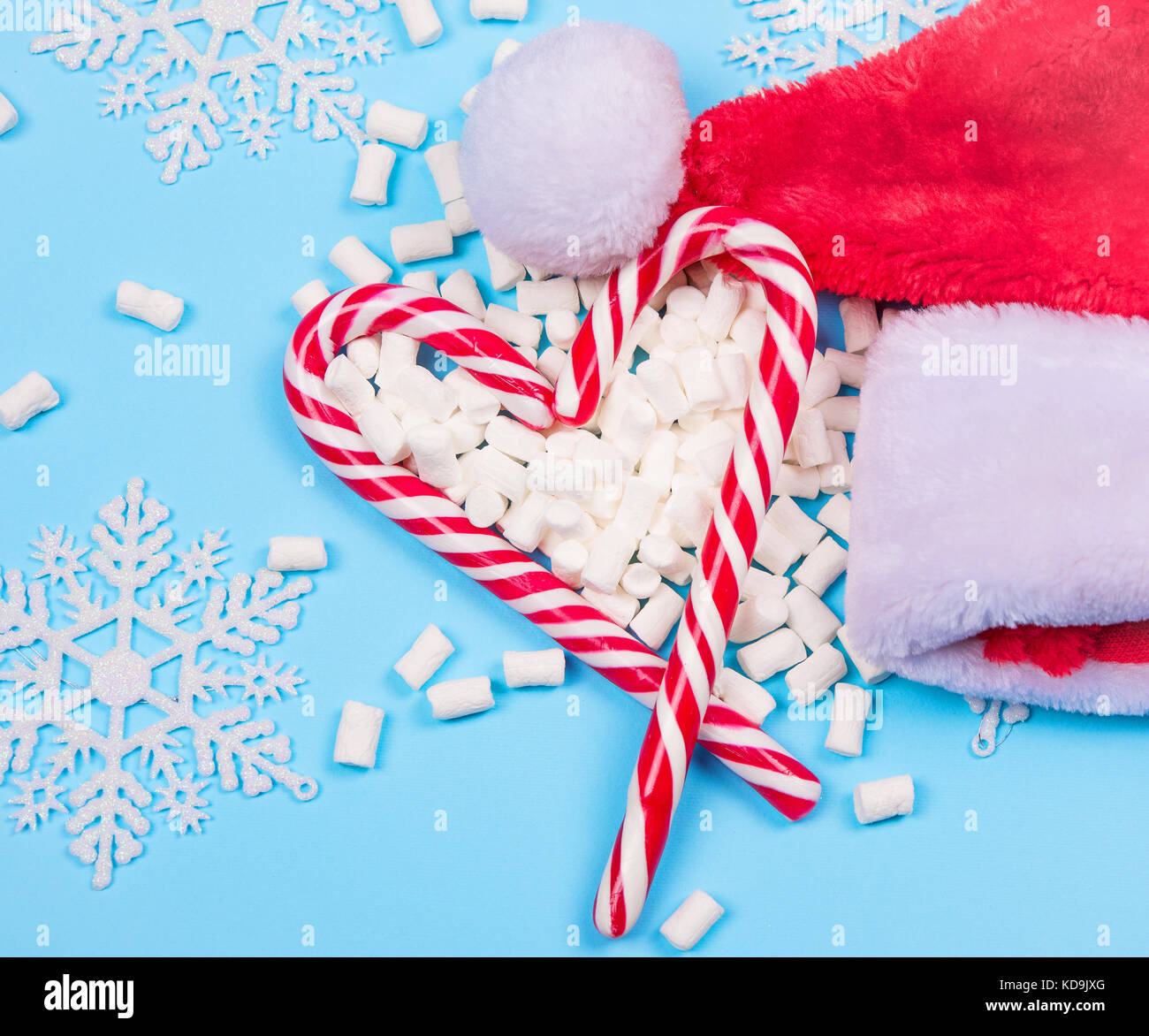 Christmas candy canes on a blue background Stock Photo - Alamy
