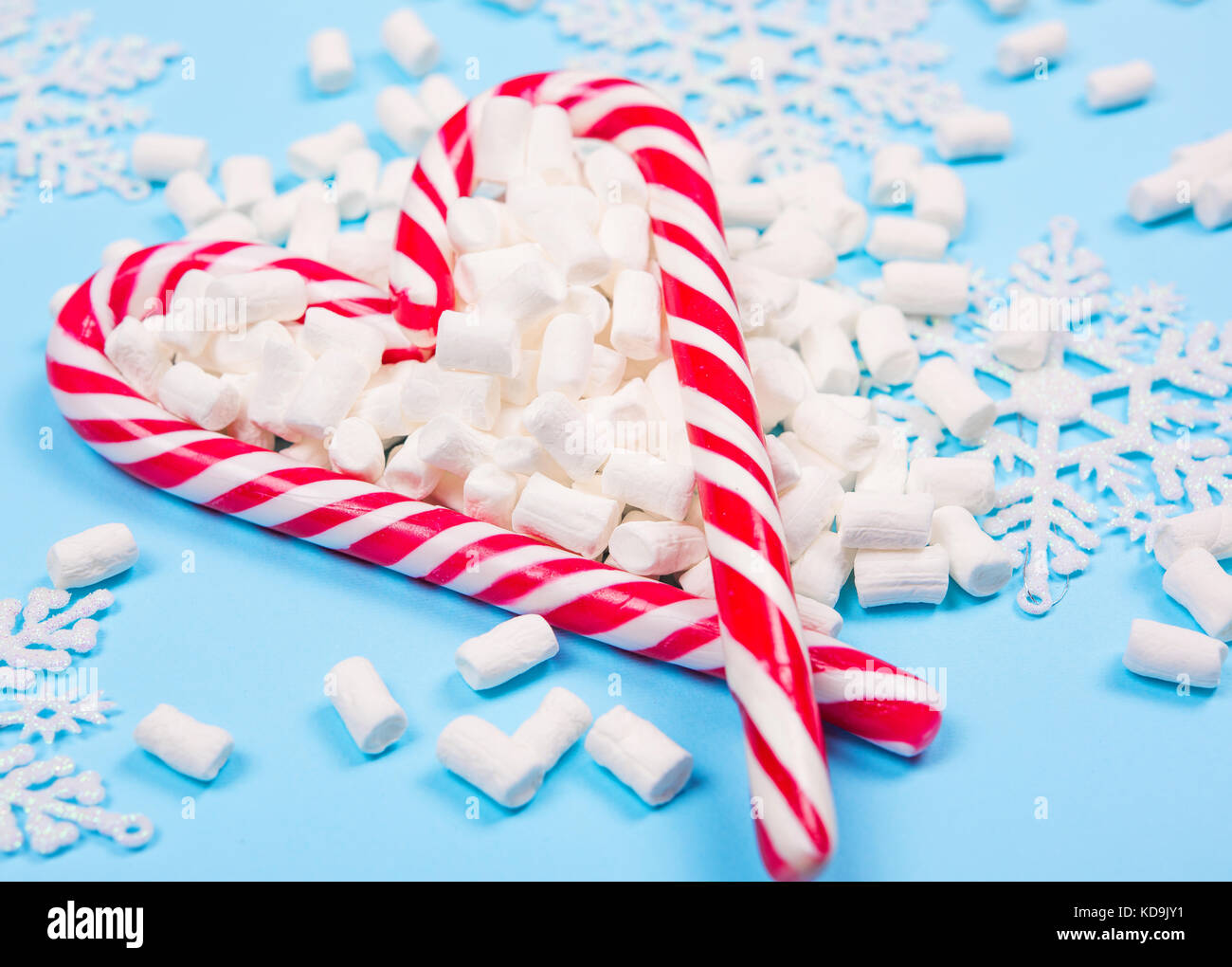 Christmas candy canes on a blue background Stock Photo - Alamy