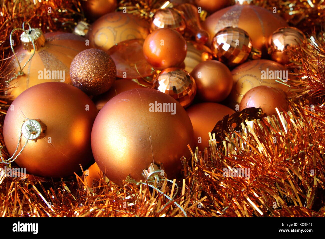 Orange Christmas balls of different sizes and tinsel Stock Photo - Alamy