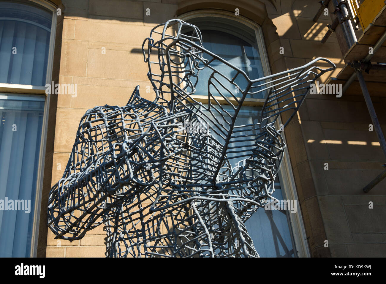 Wire sculpture of a man reading a newspaper, outside the Library ...