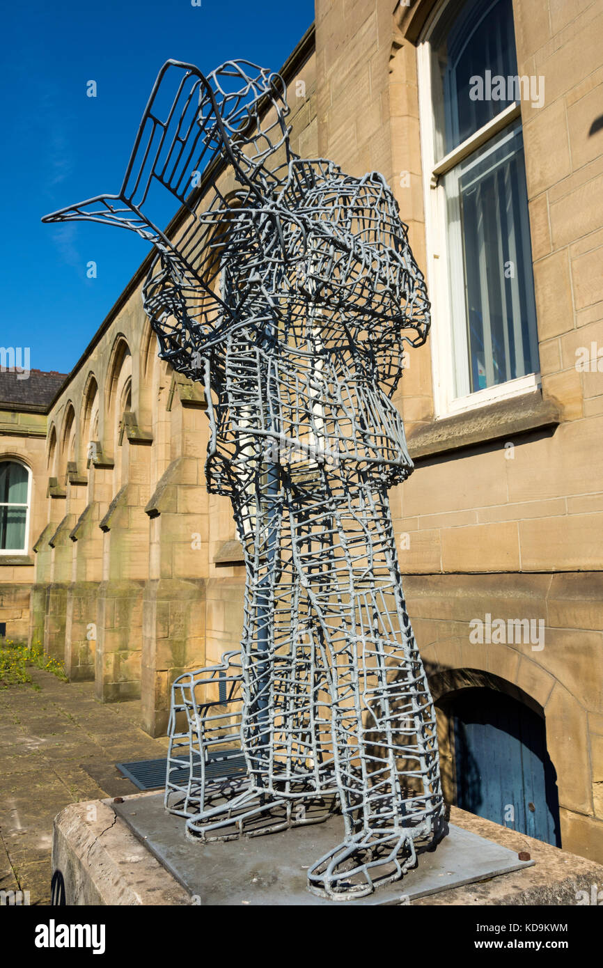 Wire sculpture of a man reading a newspaper, outside the Library ...