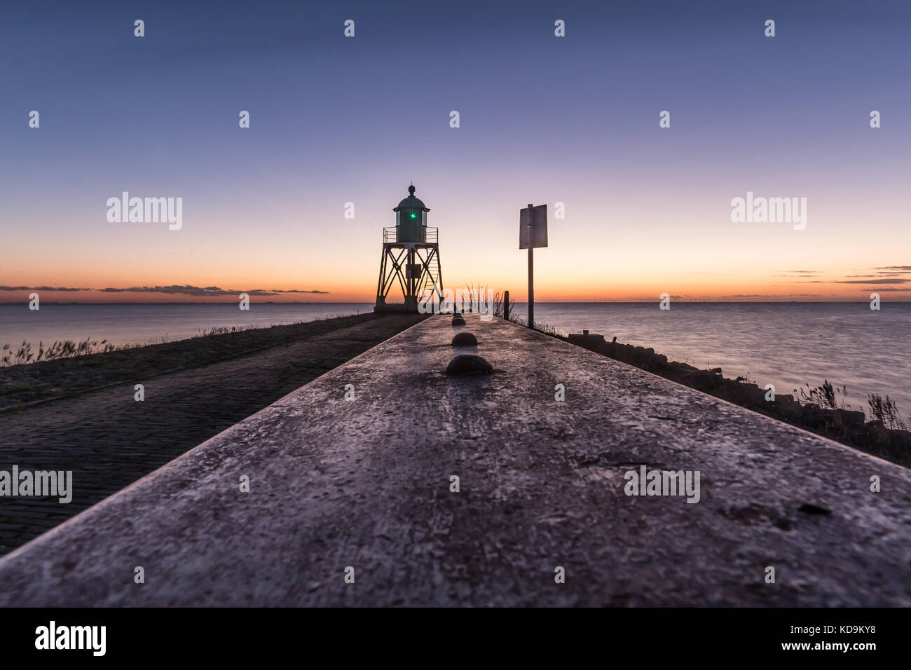 Lighthouse with sunset background Stock Photo - Alamy