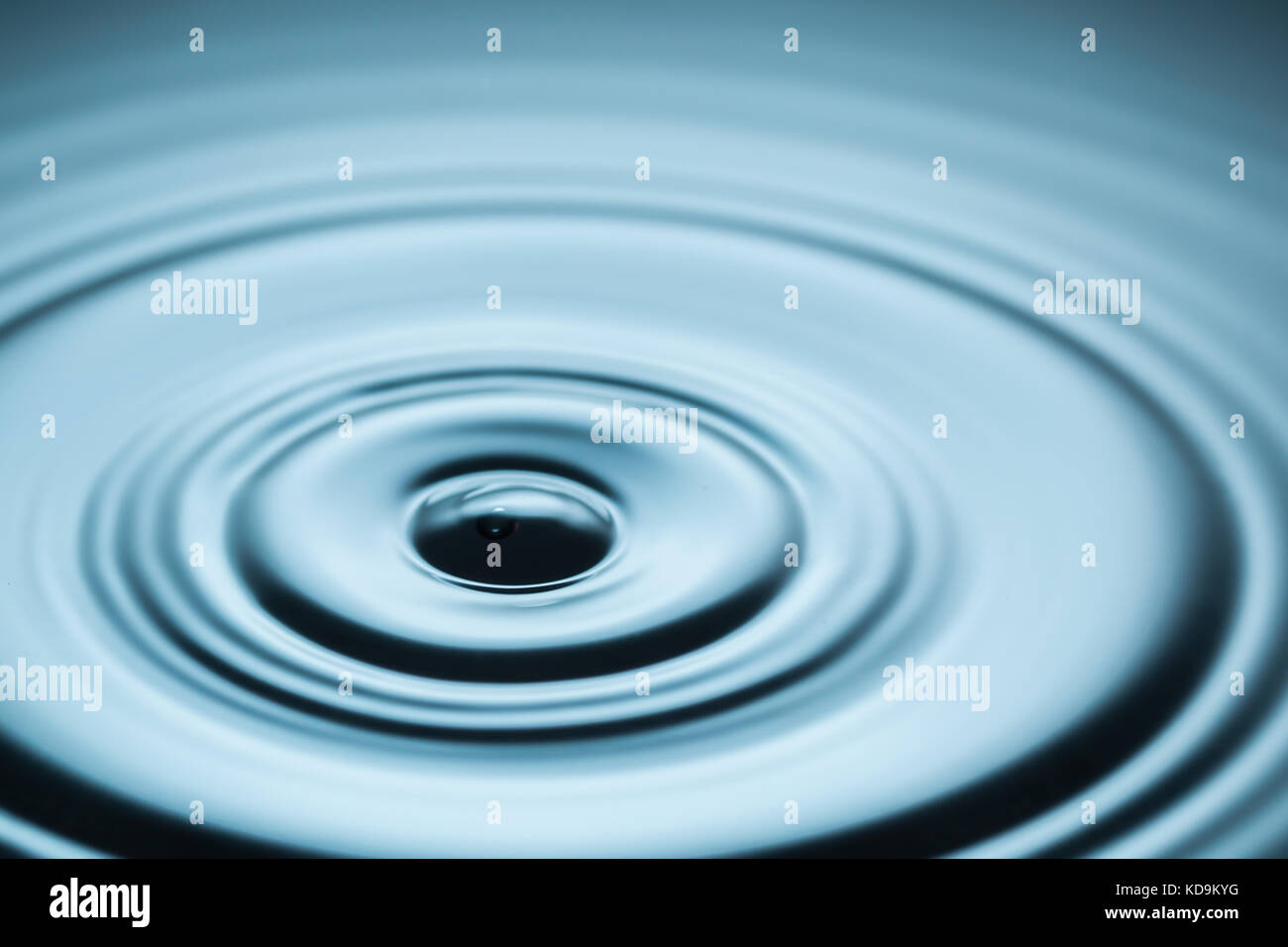 droplet falling in water surface creating circles Stock Photo - Alamy