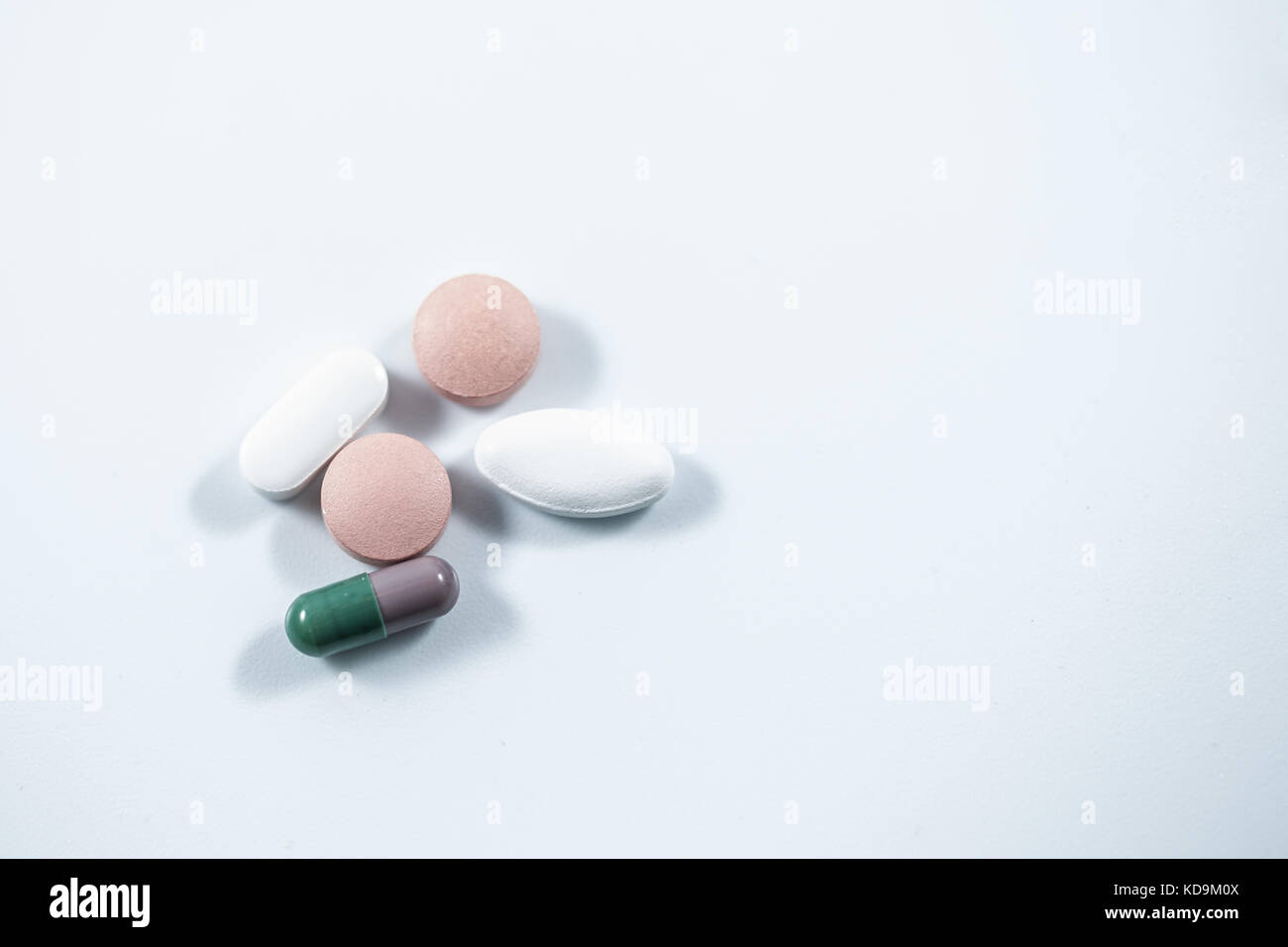 multiple pills on white background surface Stock Photo - Alamy