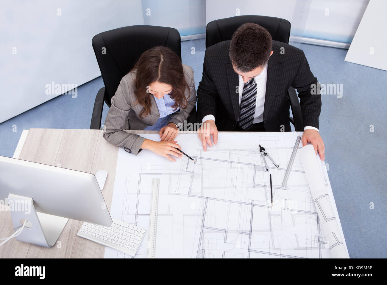 Two Architect Looking At Blue Print Discussing Together Stock Photo - Alamy