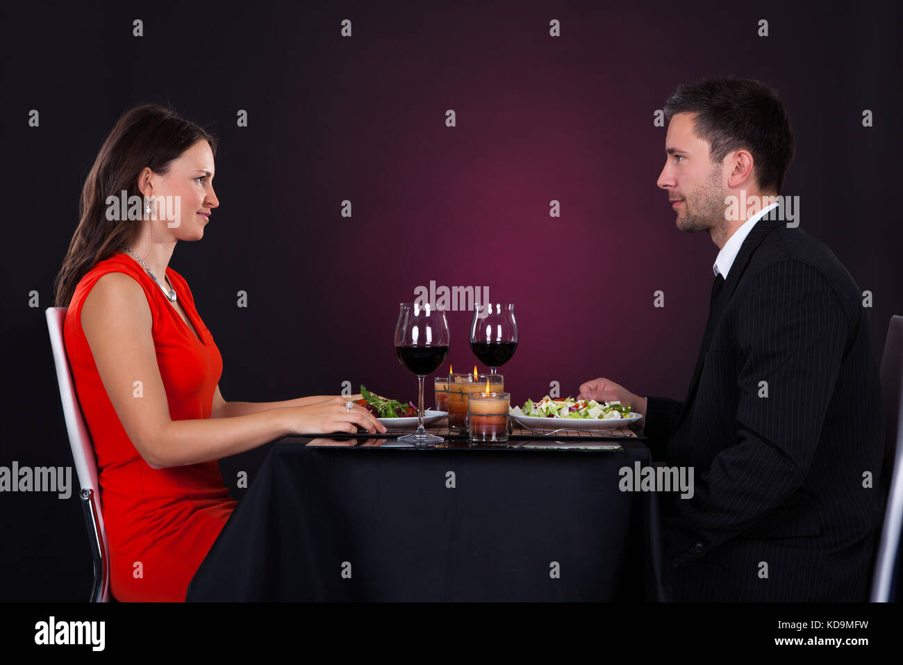 Smiling Couple Tossing Wine Glass While Having Dinner Stock Photo - Alamy