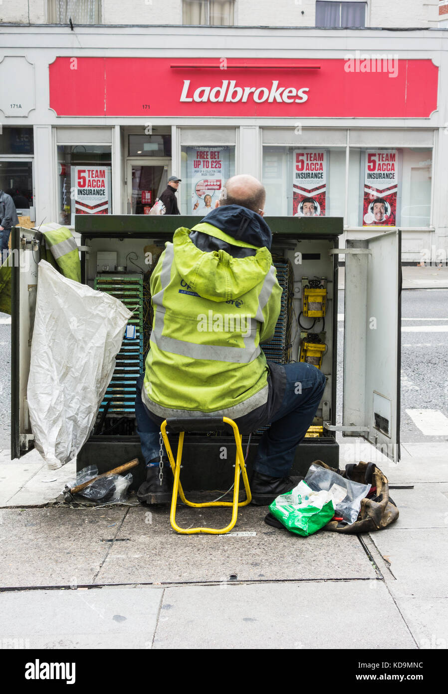 A BT Openreach Telecoms Engineer installing copper wire in a telecoms ...