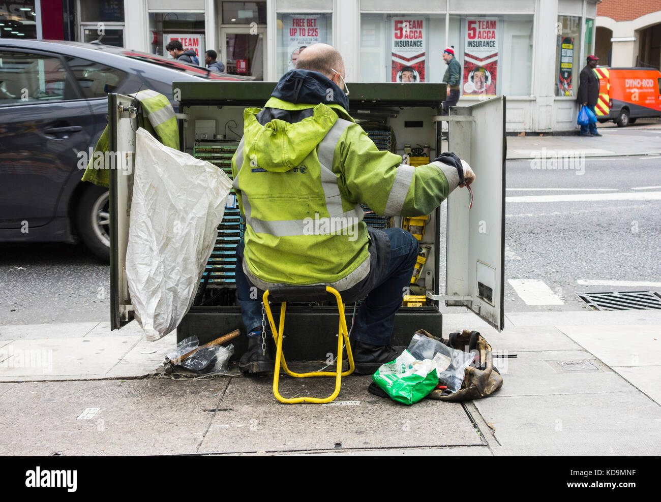 A BT Openreach Telecoms Engineer installing copper wire in a telecoms ...
