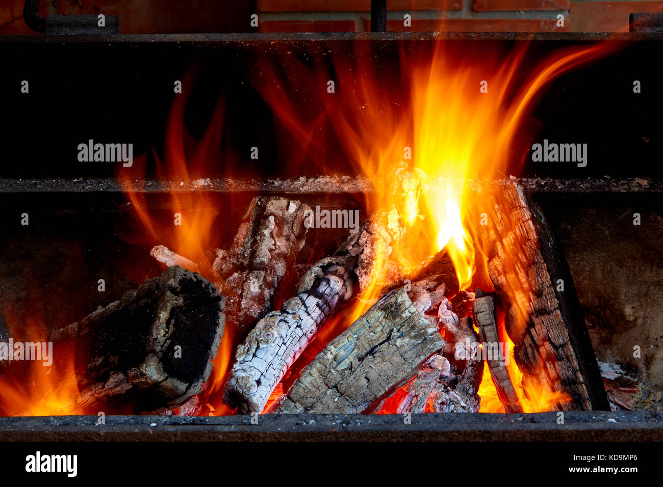 Burning firewood in the barbecue at backyard close up Stock Photo - Alamy