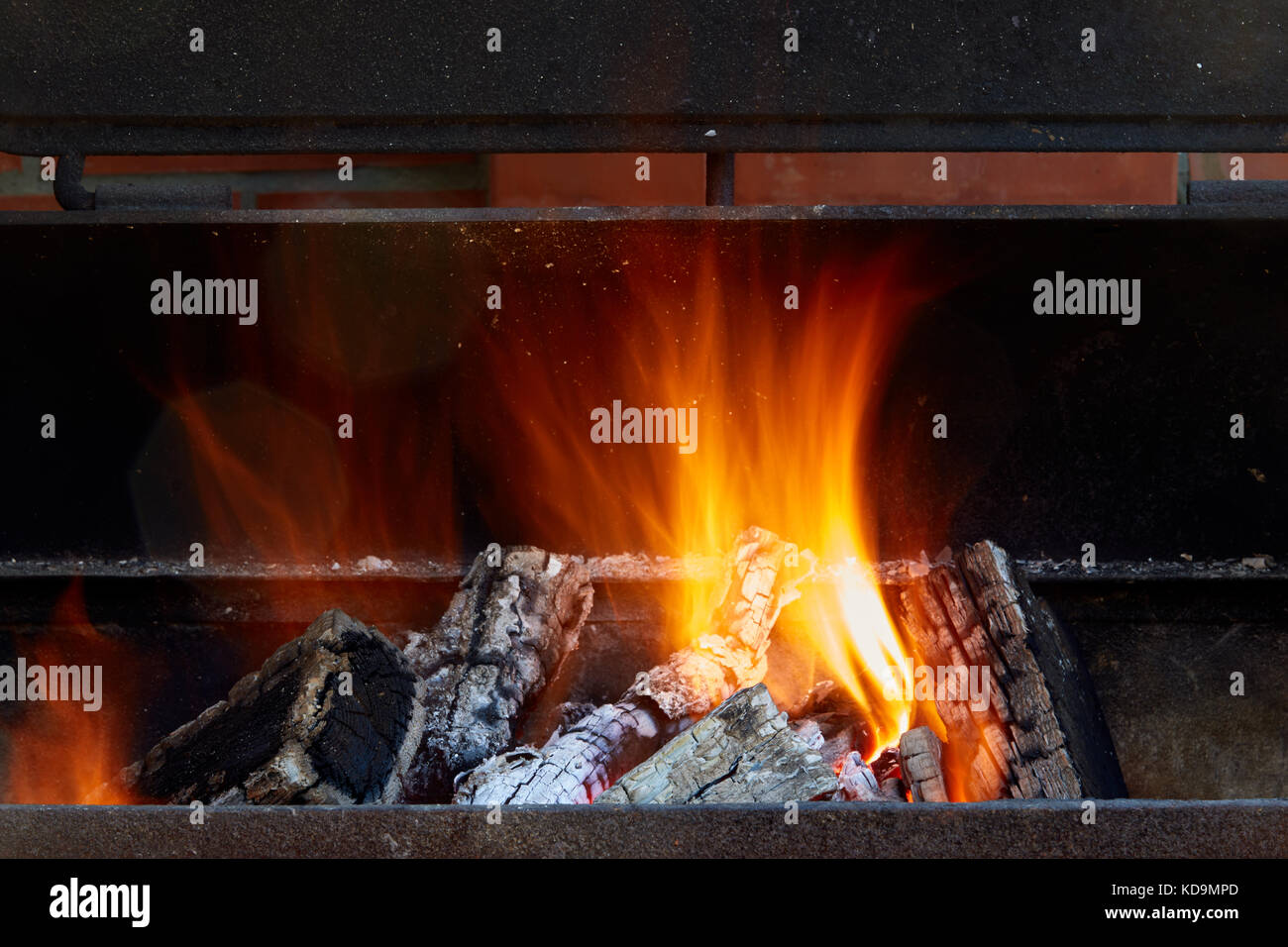 Burning firewood in the barbecue at backyard close up Stock Photo - Alamy