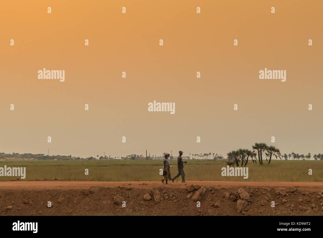 African rural people returning from work, with sunset. Sumbe. Angola ...