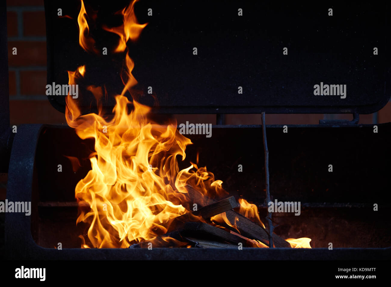 Burning firewood in the barbecue at backyard close up Stock Photo - Alamy