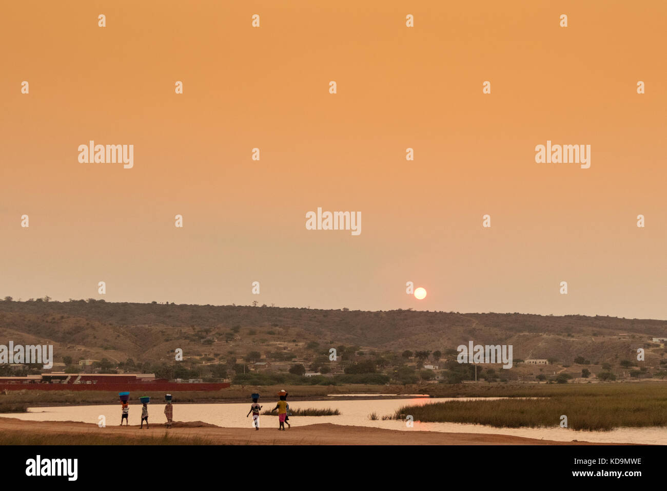 African rural people returning from work, with sunset. Sumbe. Angola ...