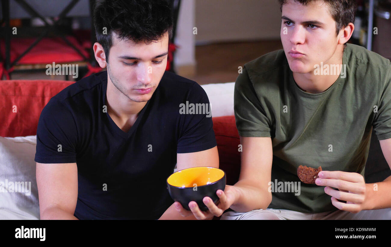 Men relaxing and enjoying snacks Stock Photo - Alamy