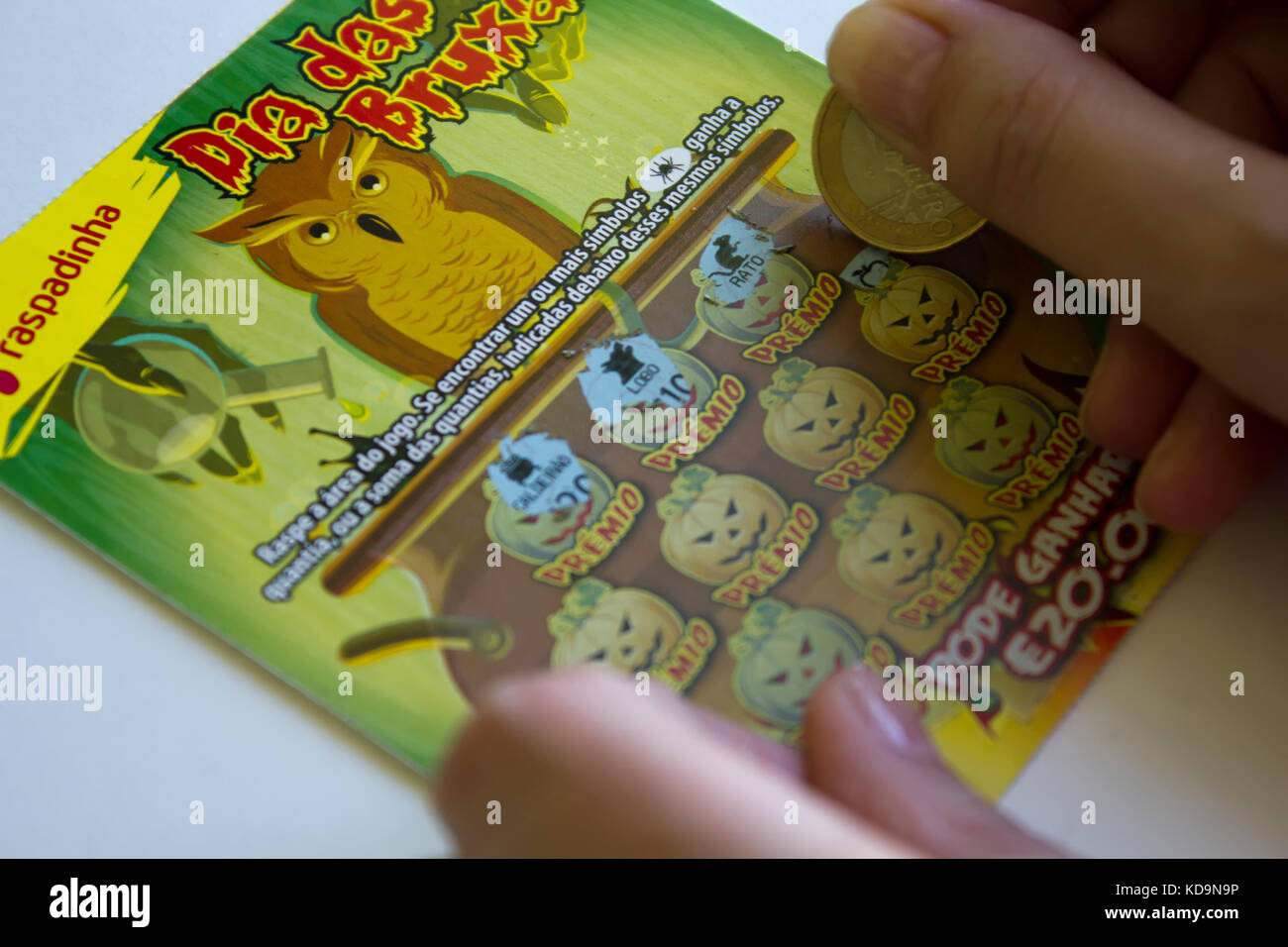 Scratching a Lottery Scratchcard with coin Stock Photo - Alamy