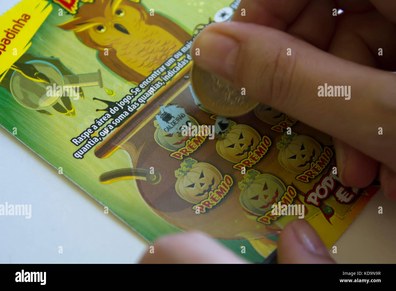 Scratching a Lottery Scratchcard with coin Stock Photo - Alamy