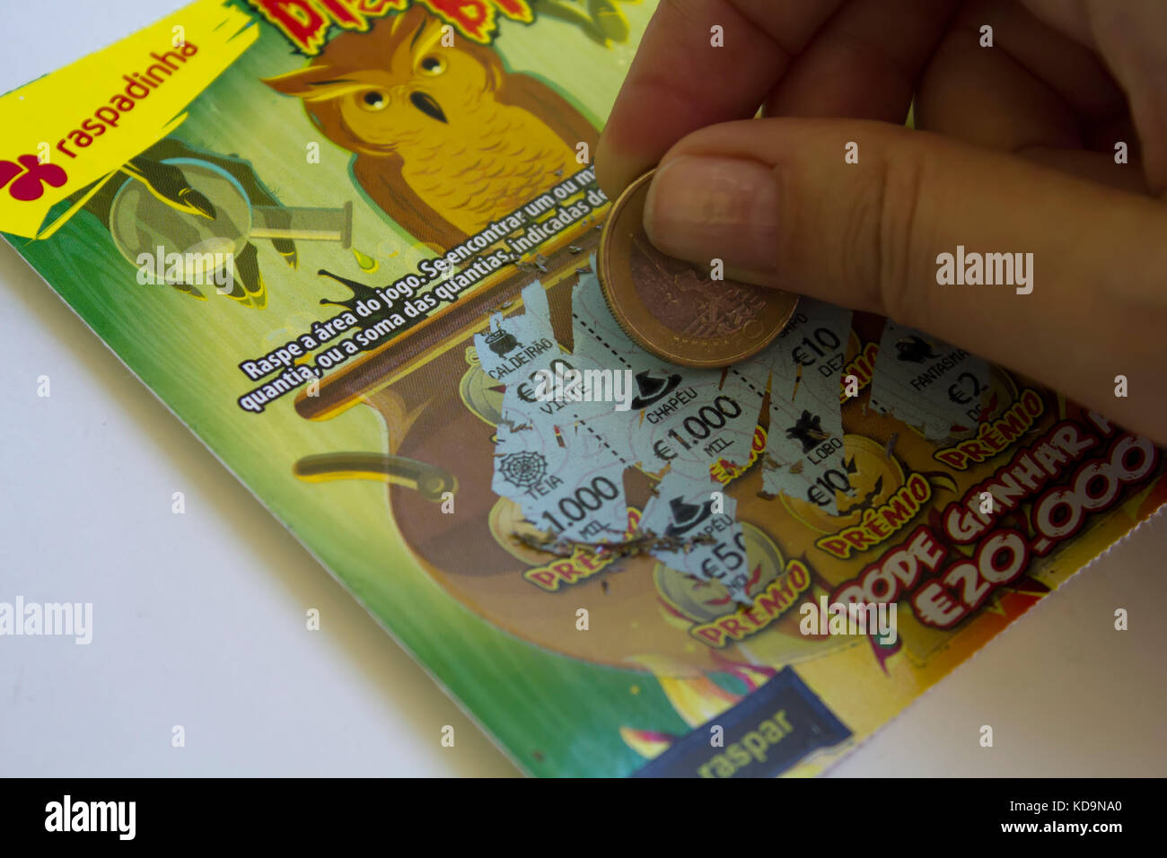 Scratching a Lottery Scratchcard with coin Stock Photo - Alamy