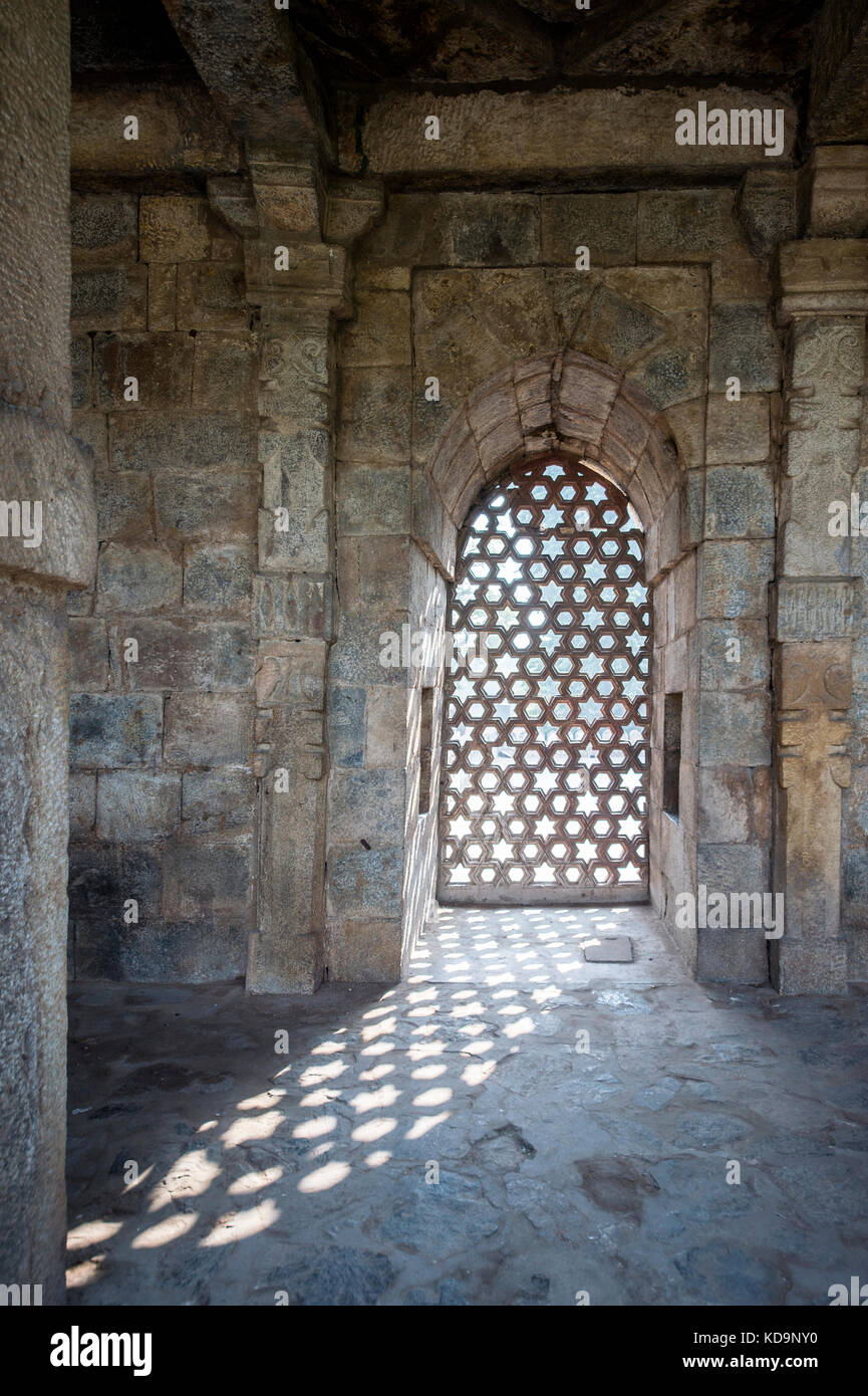Some rays of sunshine pass through a door inside the Qutub Minar ...