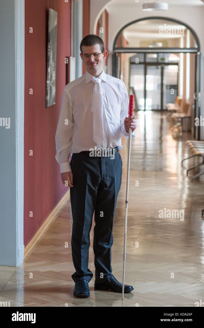 The blind honorary judge, Florian Schurbesmann, standing in a courtroom ...
