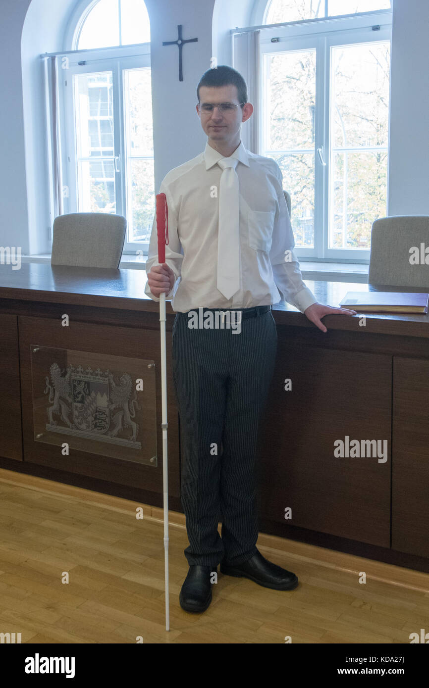 The blind honorary judge, Florian Schurbesmann, standing in a courtroom ...