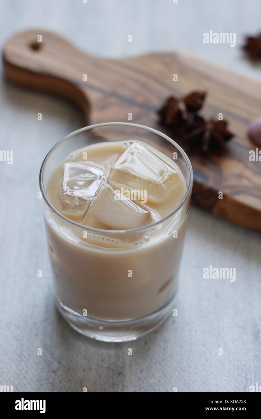 Thai sweet tea spiced with star anise with condensed milk on glass with ...