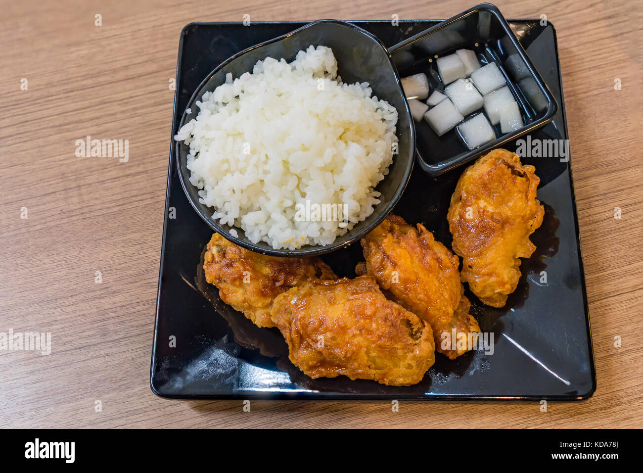 Korean sauce fried chickens Hot and Spicy served with rice on wooden ...