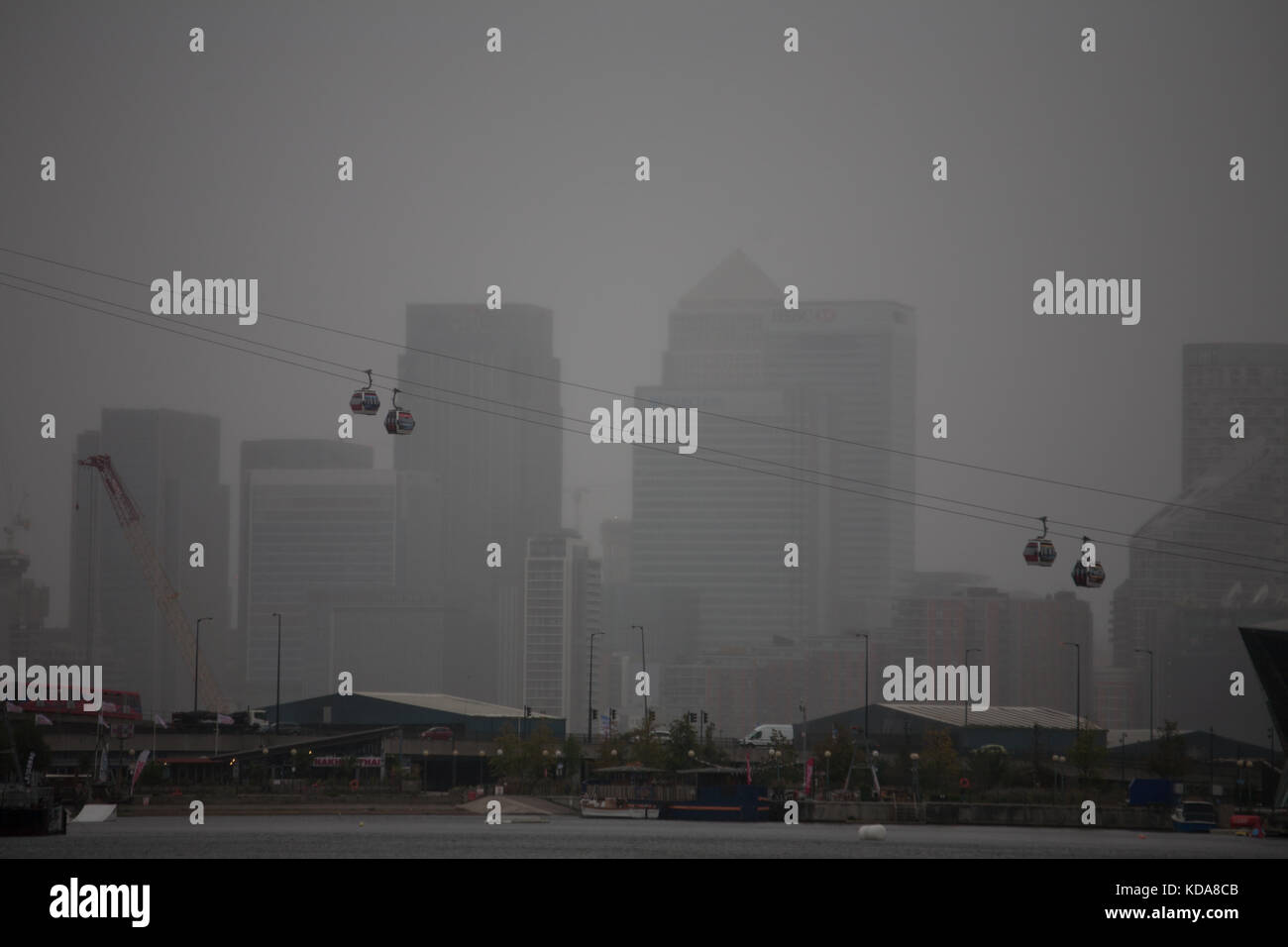 London Emirates airline cable car above River Thames with misty foggy ...