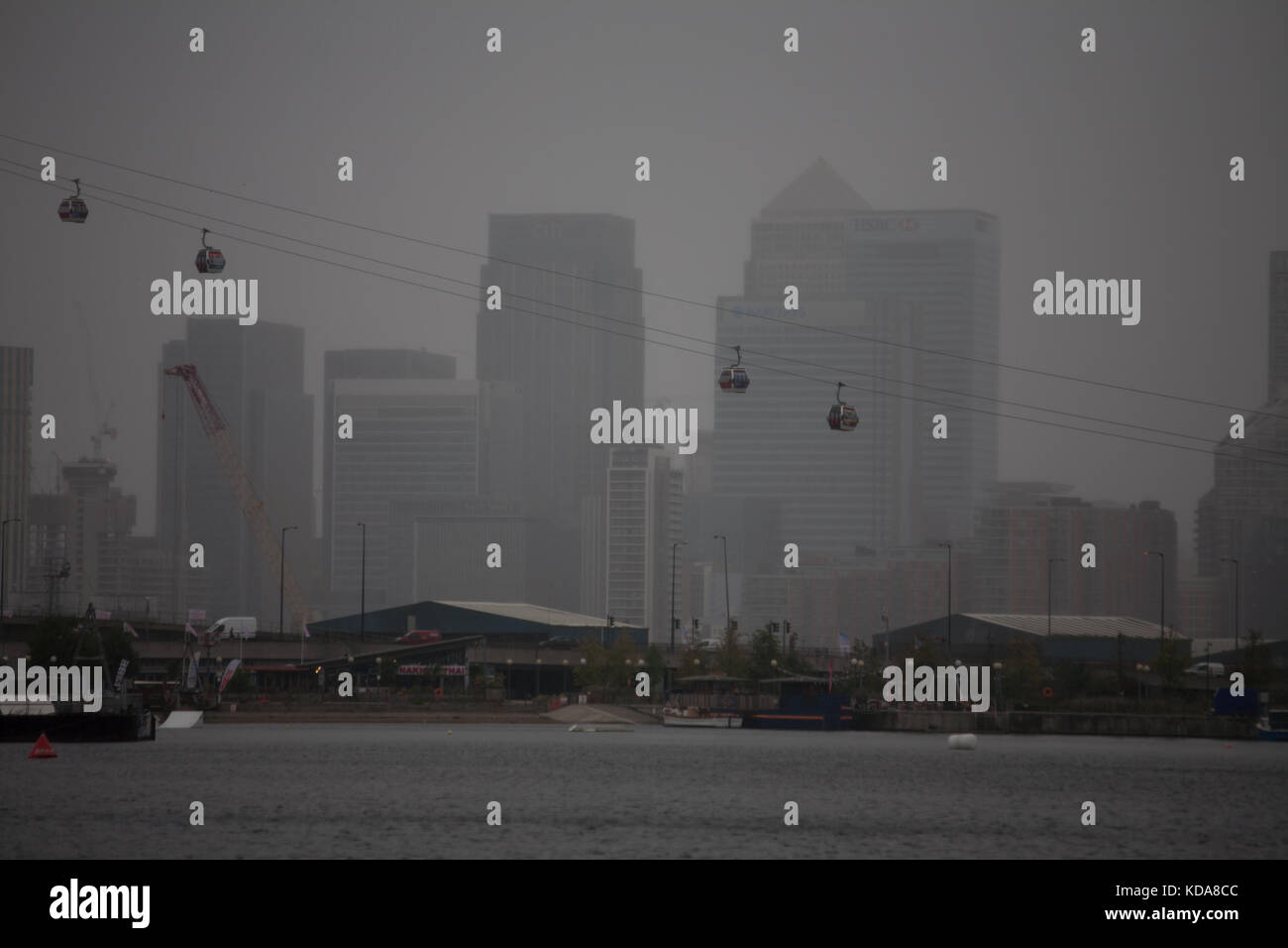 London Emirates airline cable car above River Thames with misty foggy ...