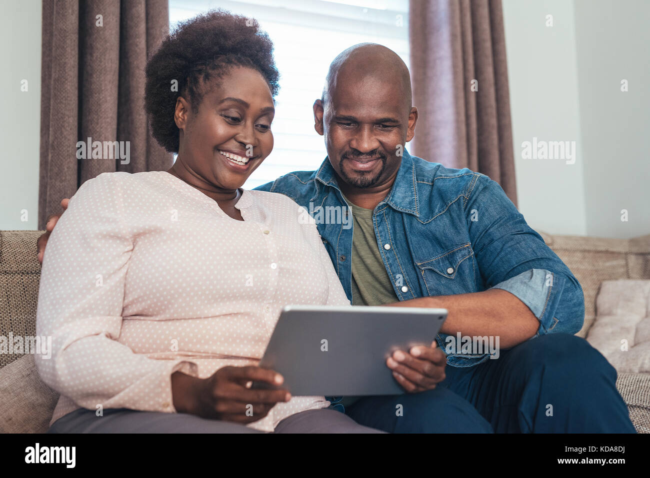 Black couple sitting hi-res stock photography and images - Alamy
