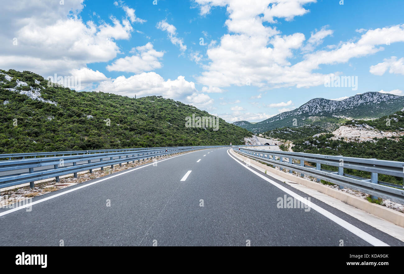 High-speed country road among the mountains Stock Photo - Alamy