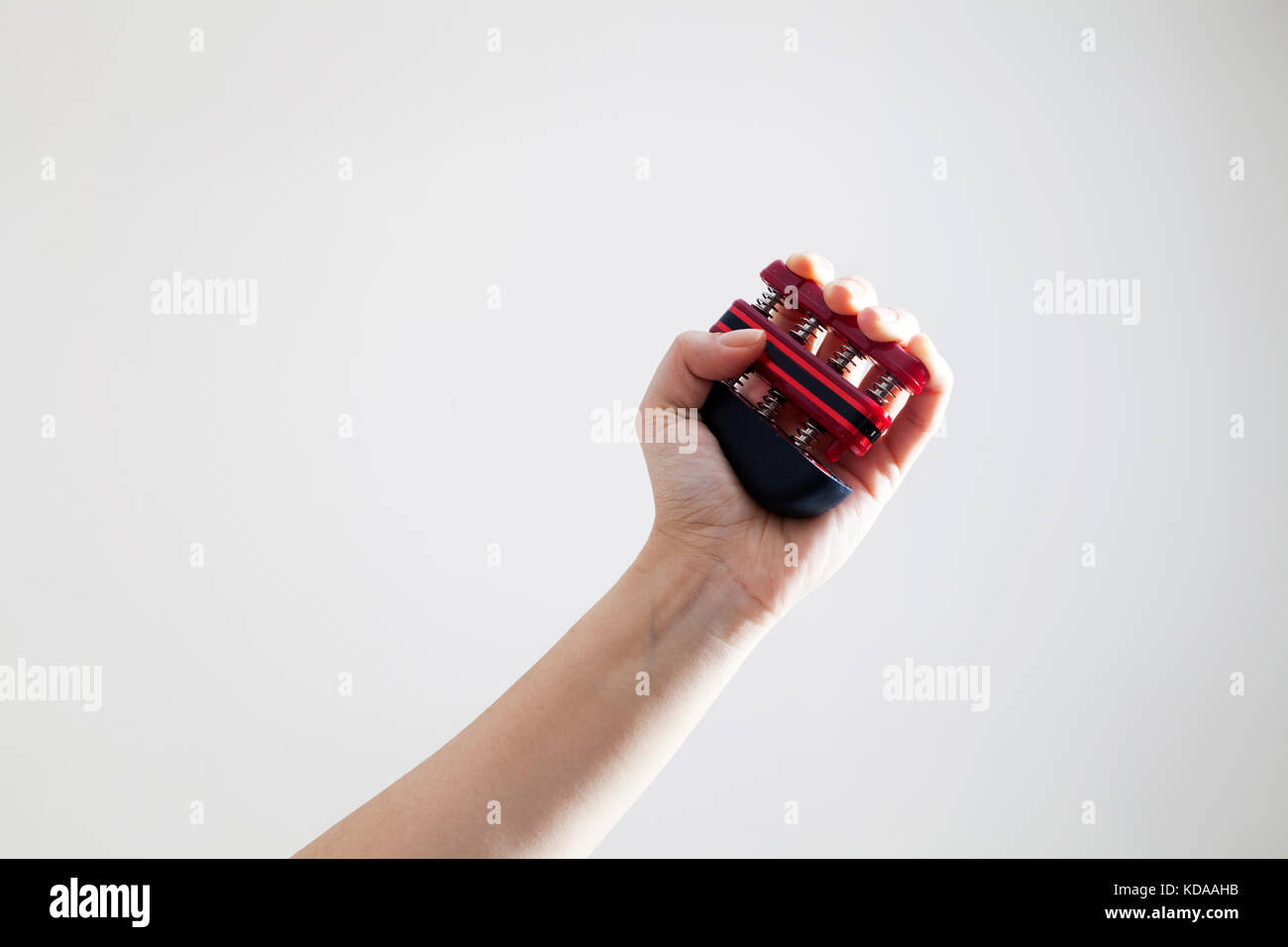 Hand holding gripper isolated on white background Stock Photo - Alamy