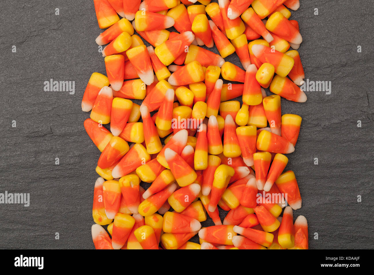 Halloween candy corn sweets on a slate background Stock Photo - Alamy
