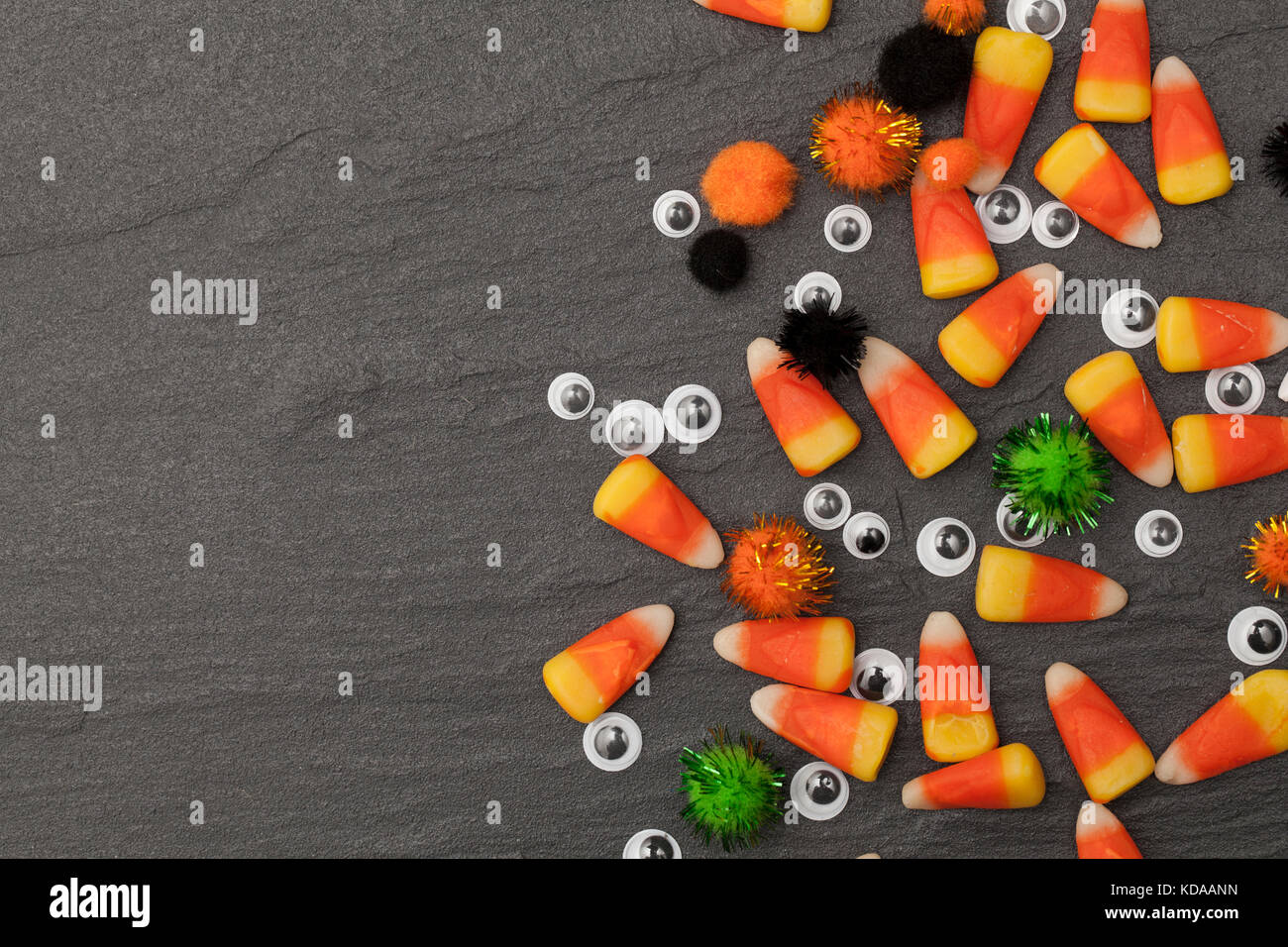 Halloween candy corn sweets and googly eyes background Stock Photo - Alamy
