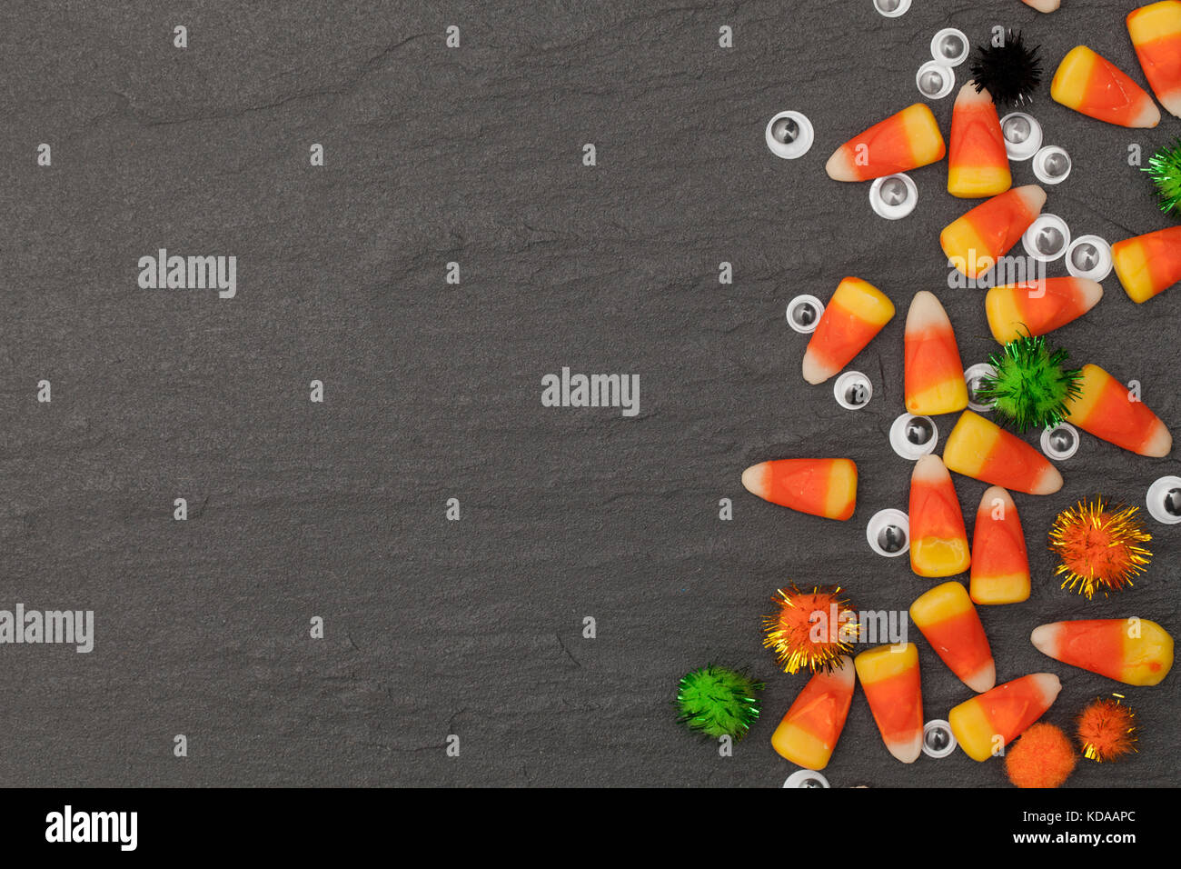 Halloween candy corn sweets and googly eyes background Stock Photo - Alamy