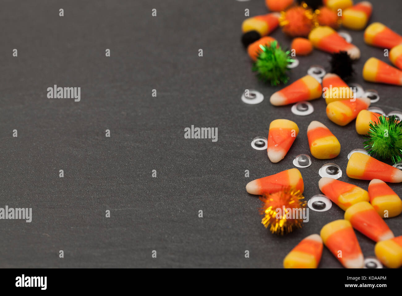 Halloween candy corn sweets and googly eyes background Stock Photo - Alamy