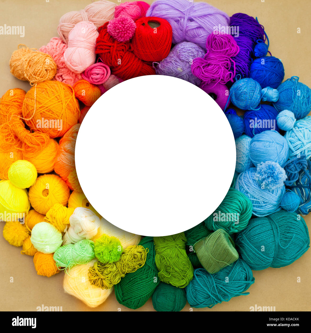 Colorful yarn stacked in a series of colors. Background brown kraft ...