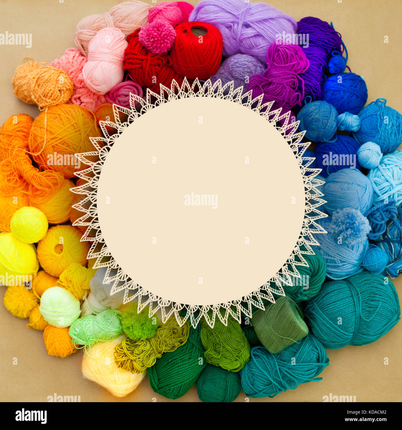 Colorful yarn stacked in a series of colors. Background brown kraft ...