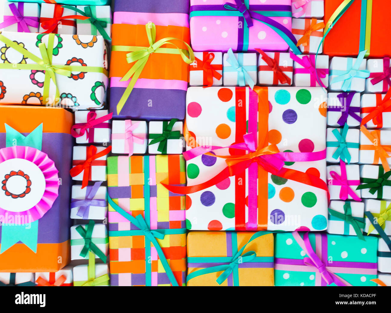 Colored gift boxes with colorful ribbons. White background. Gifts for ...