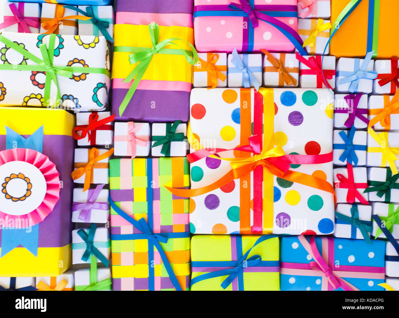 Colored gift boxes with colorful ribbons. White background. Gifts for ...