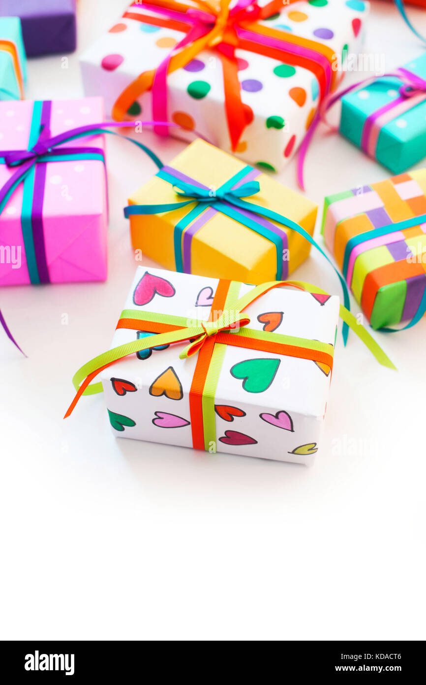 Colored gift boxes with colorful ribbons. White background. Gifts for ...