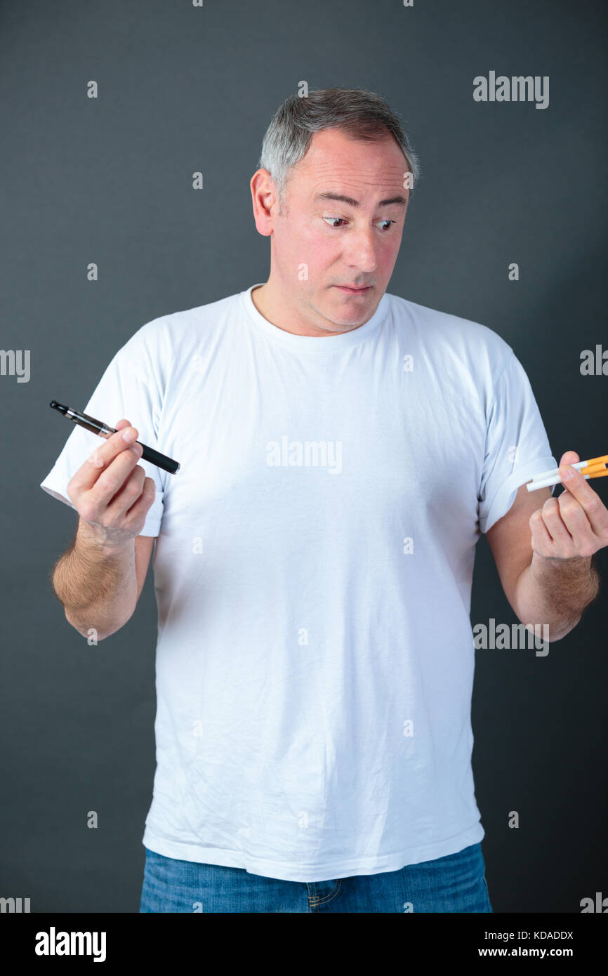 man holding two pens Stock Photo - Alamy